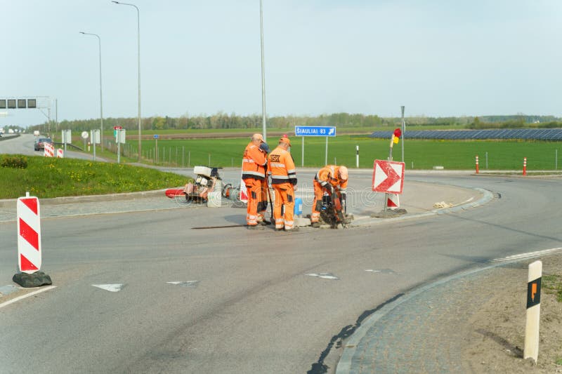 Road Construction Crew Working on a Roundabout in the Daytime Editorial ...