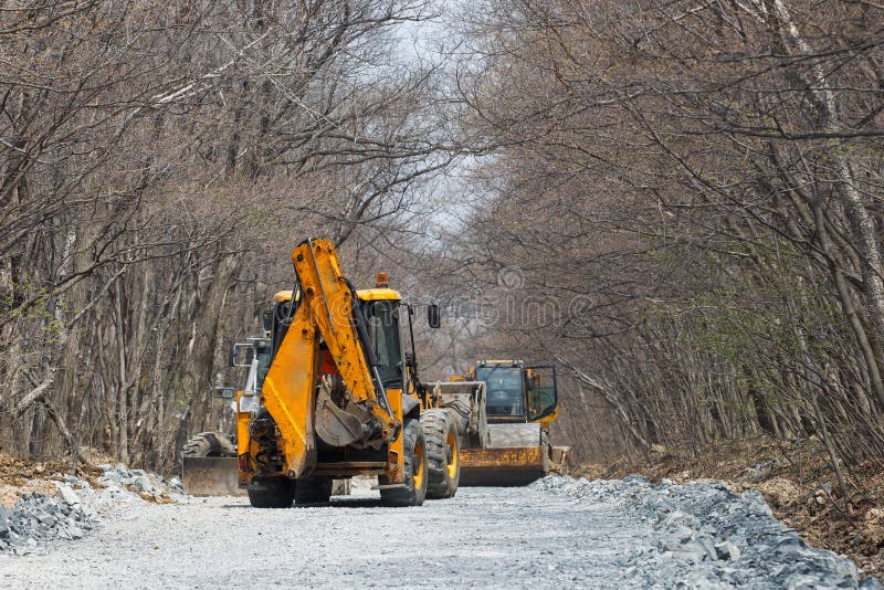 Road Construction Machinery Stands on a Dirt Road. Stock Photo - Image ...
