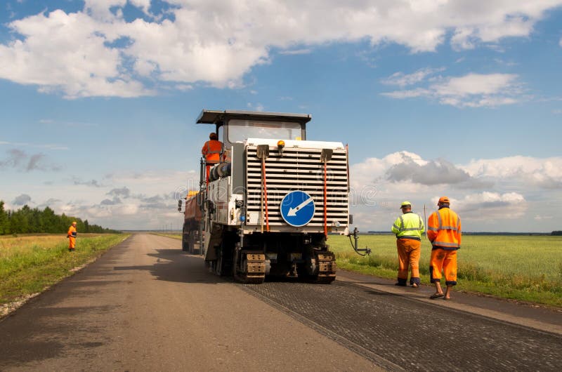 Road Construction in Progress, Worker on Road with Large Machine and ...