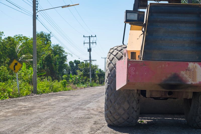 Road Construction Vehicle on the Rough Rural Road. Stock Photo - Image ...
