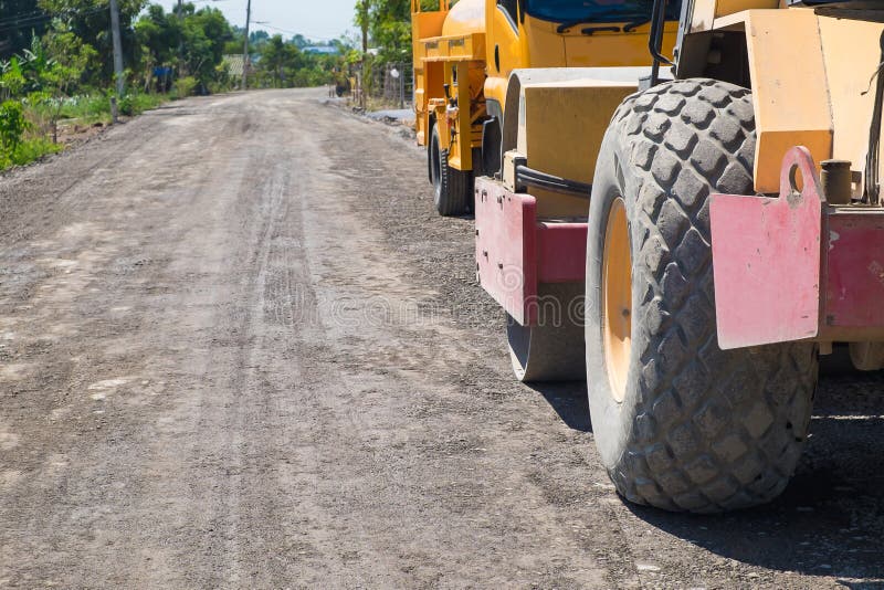 Road Construction Vehicle on the Rough Rural Road. Stock Image - Image ...