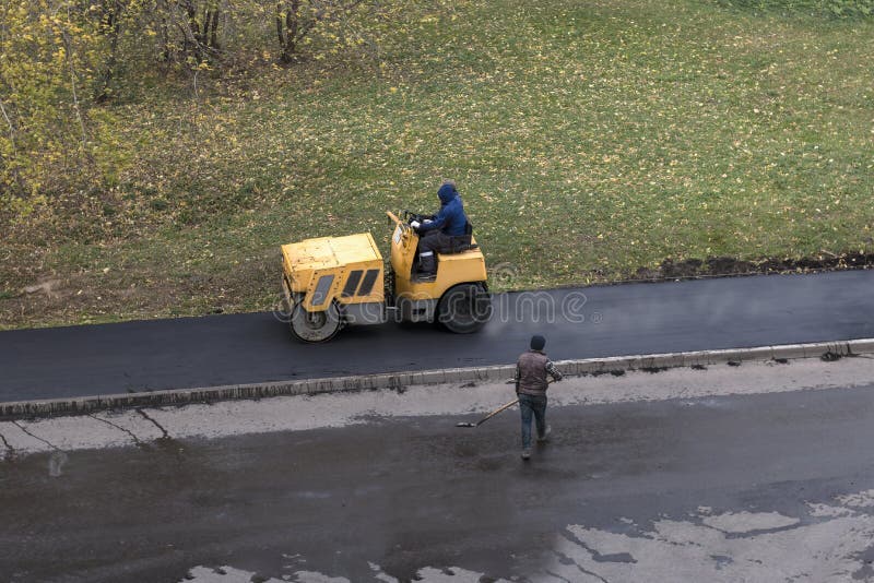 Road Construction Worker Drives Roller Compactor Machine Stock Photo ...