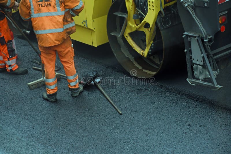 Road Construction Workers Working with Gas Burner To Heat Asphalt ...