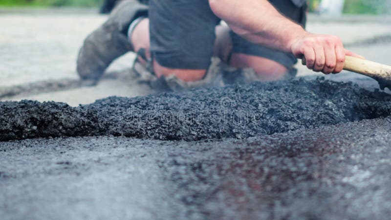 Road Construction Workers Manually Spread and Adjust Hot Tar or Asphalt ...