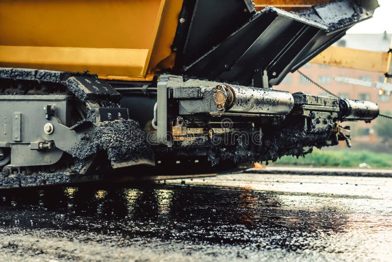 Asphalt laying machines stock image. Image of cobblestones - 121672989
