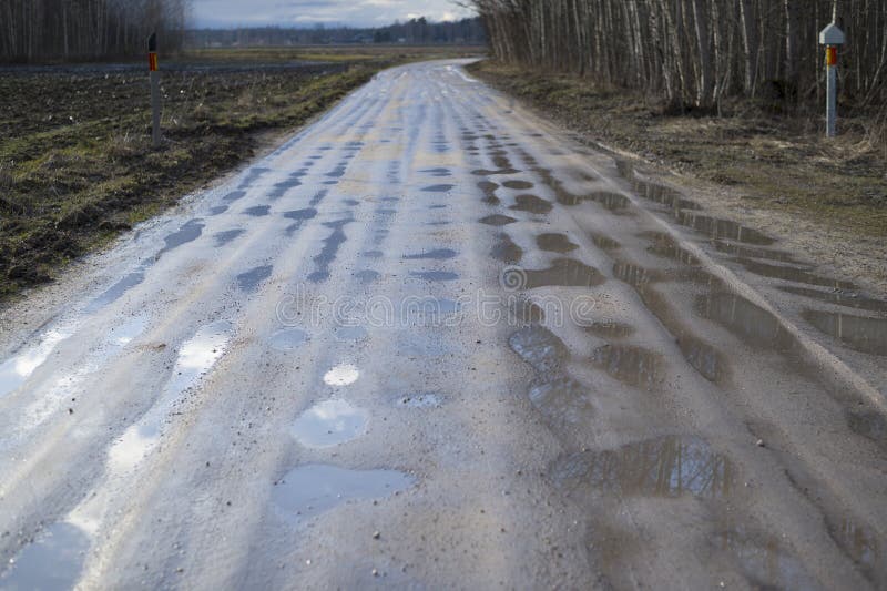 Road in Countryside with Lots of Potholes Filled with Water Stock Image ...