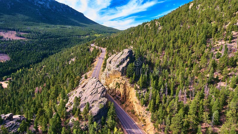Road Cutting through Large Mountain Rock in Valley of Pine Trees Stock ...