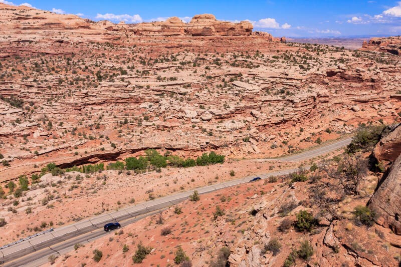 A Road in the Desert with a Car Driving Down it Stock Image - Image of ...