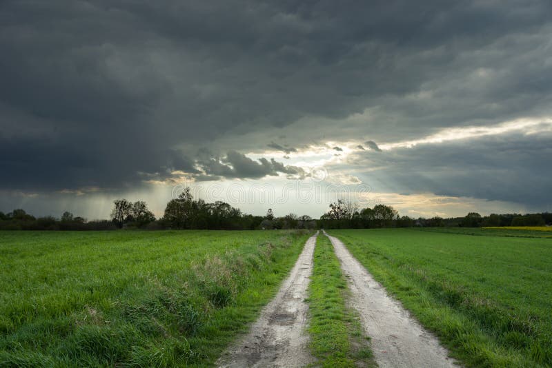 The Road in the Field and a Dark Rainy Cloud Stock Image - Image of ...