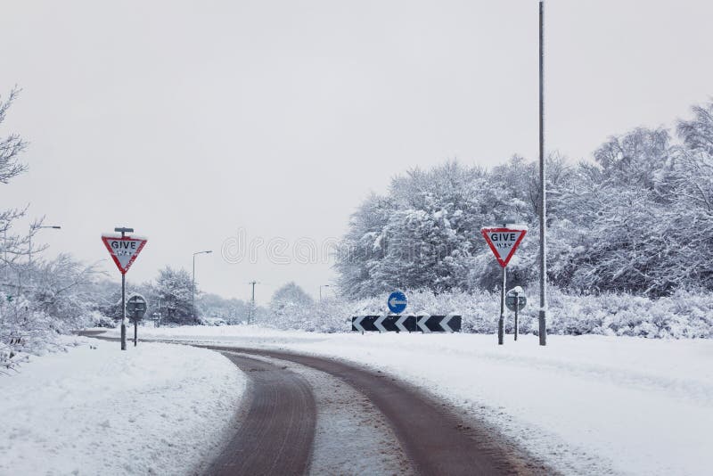 Road with Give Way Signs in the Snow Stock Photo - Image of daytime ...