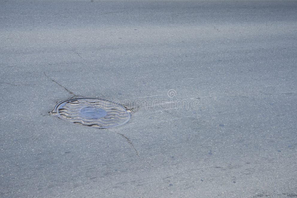 Road with a hatch stock photo. Image of hole, metal, green - 97071532