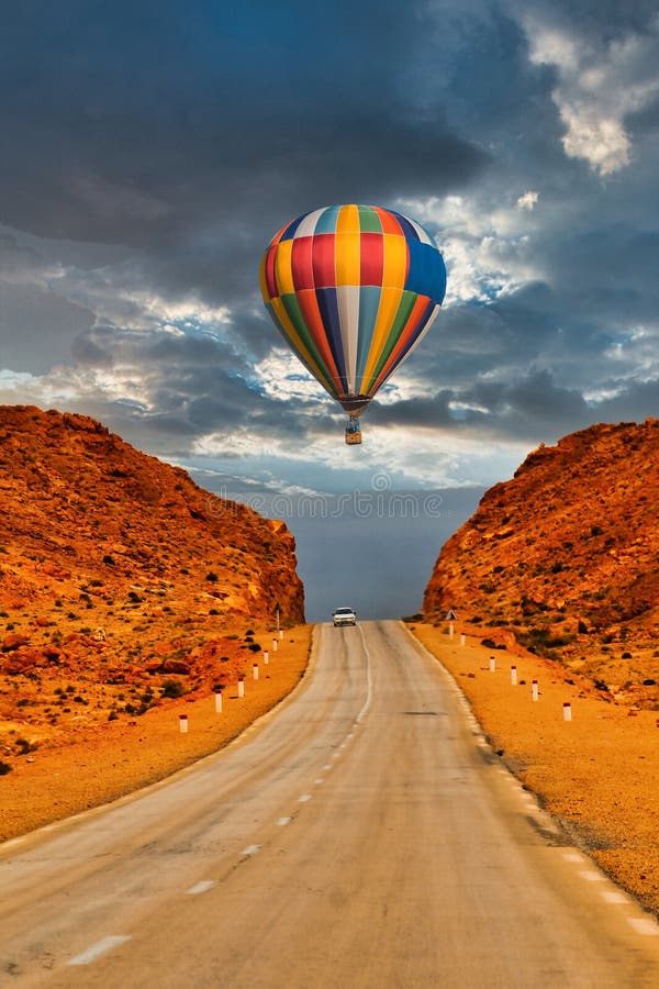 A Road between a Hill and Baloon Stock Photo - Image of tree, sunset ...