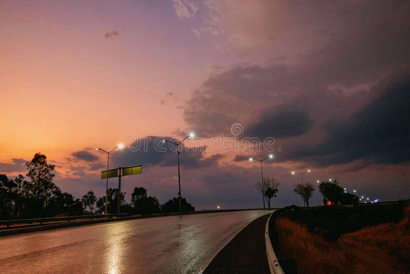 Road Illuminated by Lamps in Beautiful Sunset Stock Photo - Image of ...