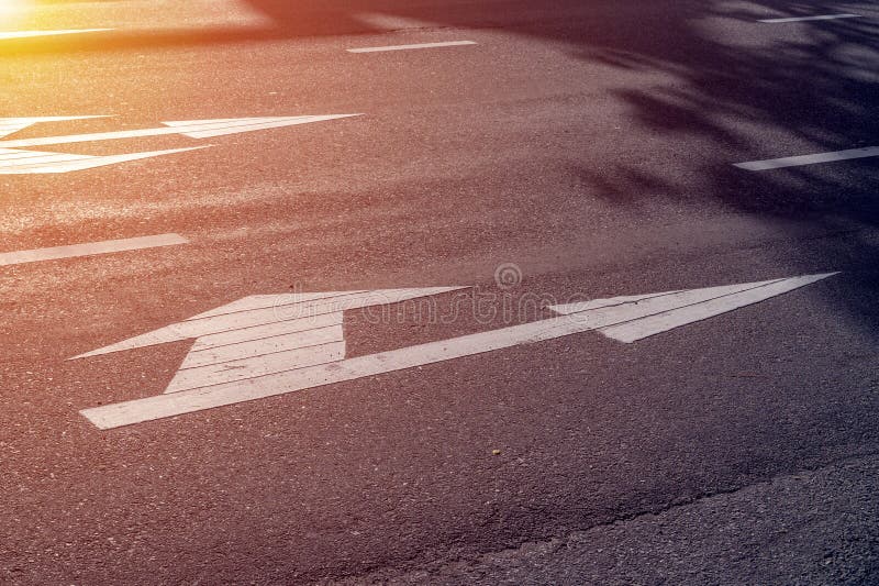 Road Intersection with Arrow Markings at Sunset Stock Photo - Image of ...
