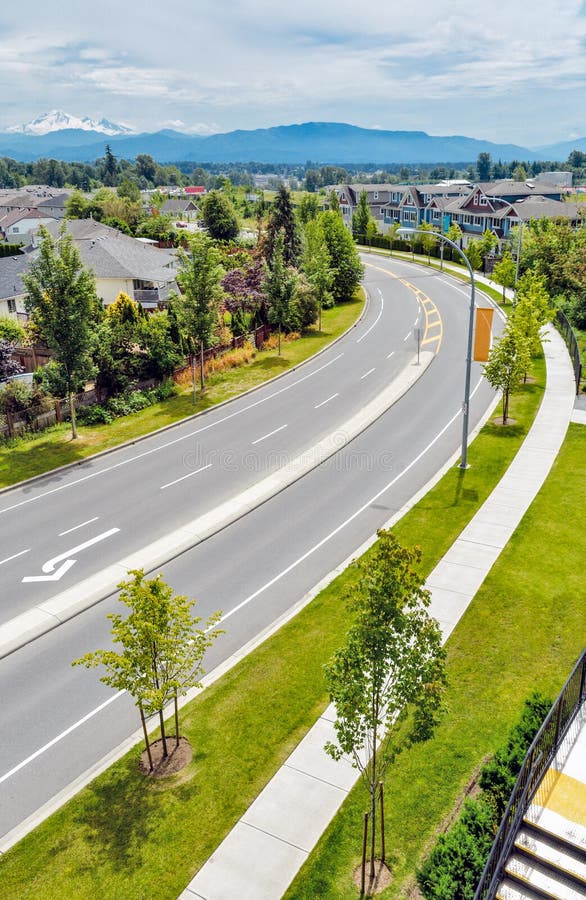 Road Leading through Residential Area with Mountain View on Skyline ...
