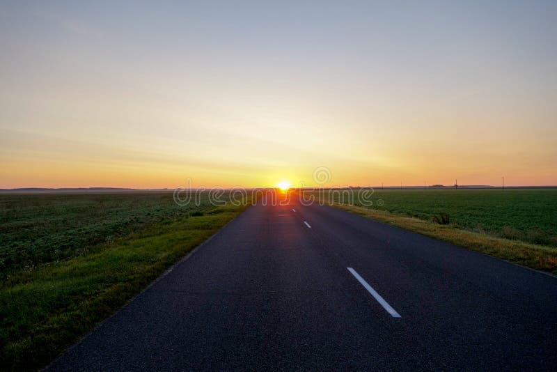 The Road Leading Straight To the Rising Sun at Dawn Stock Photo - Image ...