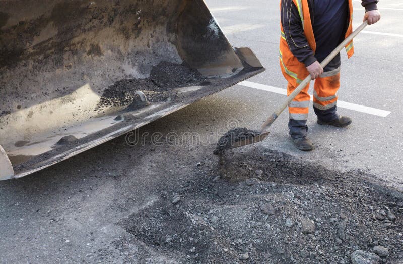 Partial Repair of the Asphalt Road. the Worker Cleans a Bad Part of the ...
