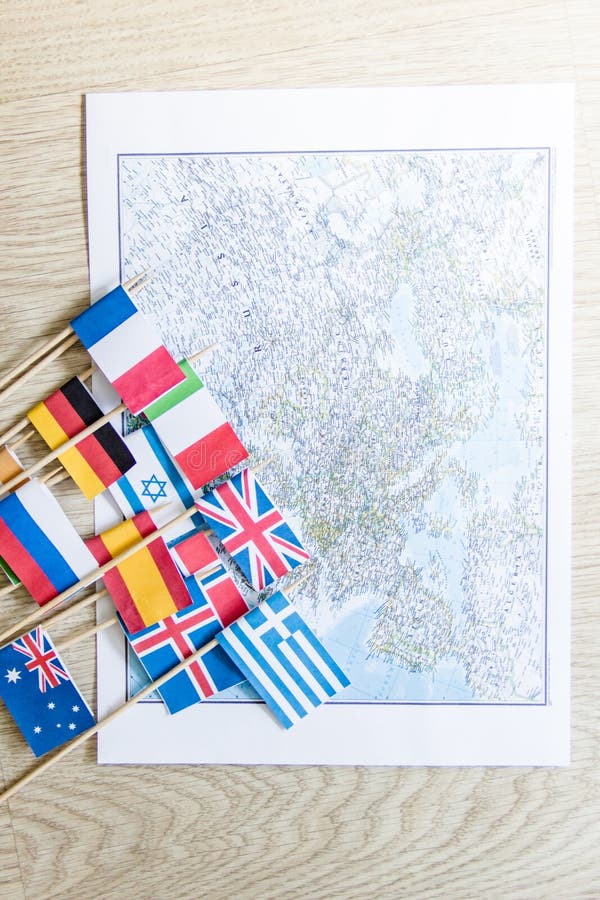 Road Map ,open Notebook, National Flags on Wooden Table. Vacation Plan ...