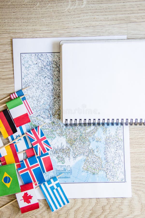 Road Map ,open Notebook, National Flags on Wooden Table. Vacation Plan ...