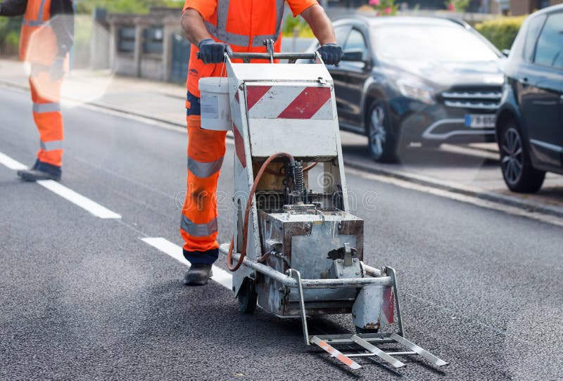 Road Marking Applicator Working on the White Lines in the Middle of a ...