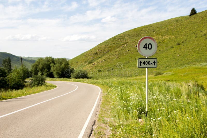 Road in the Mountains with a Speed Limit Sign on the Side of the Road ...