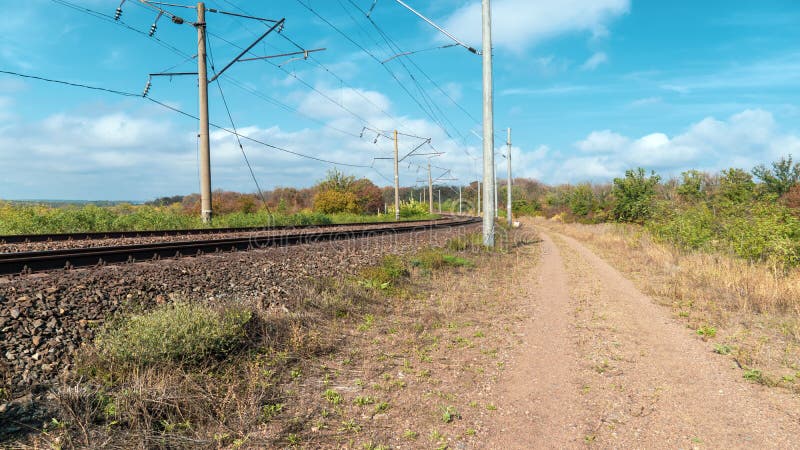 A Road Parallel To the Tracks Stock Photo - Image of plant, road: 198113164