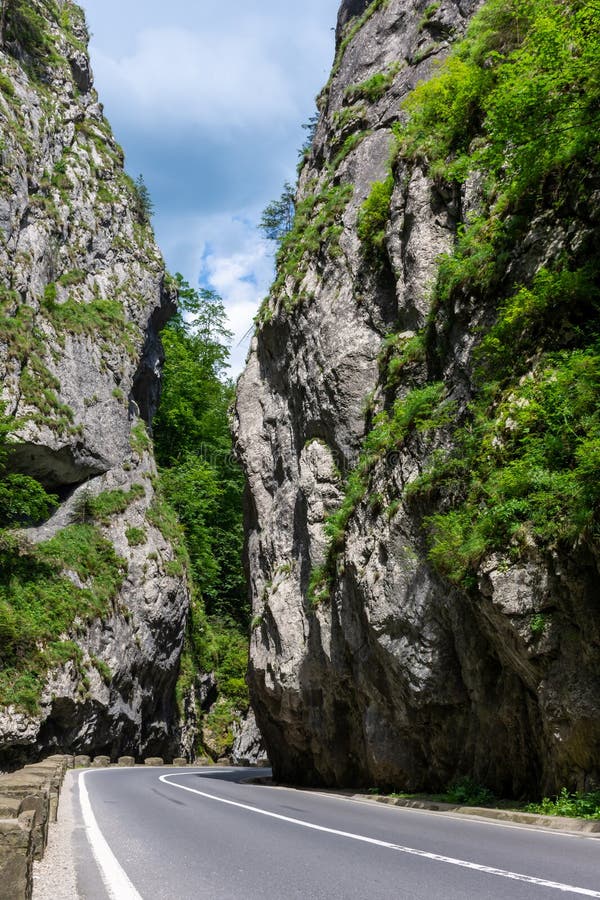 A Road Passing through a Canyon with Rocky Cliffs on Each Side Stock ...