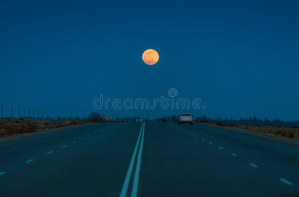 Road Perspective at Dusk with Big Moon Stock Photo - Image of moon ...