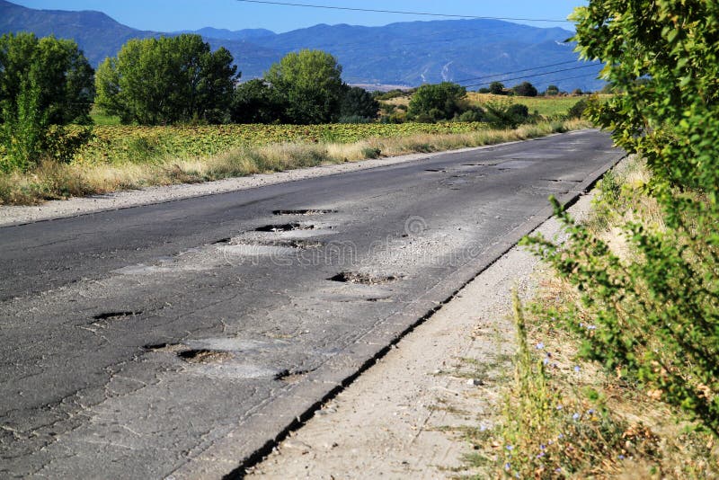 Road with Potholes stock image. Image of pavement, black - 49984537