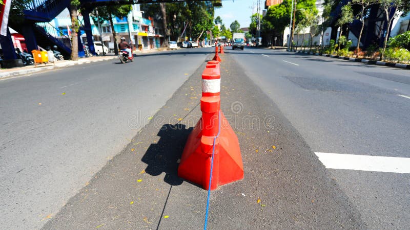 A road with a red cone editorial stock photo. Image of cone - 381933458