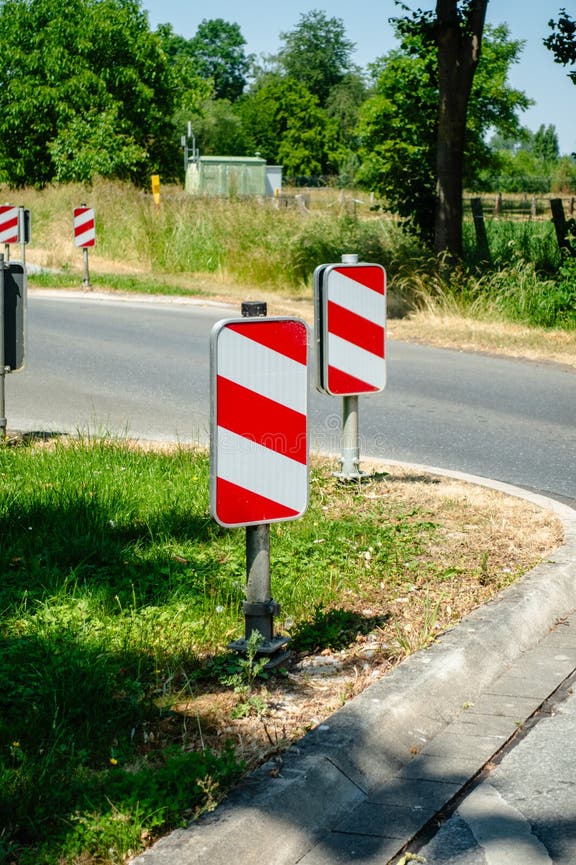 A Road with a Red and White Striped Sign on the Side Stock Image ...