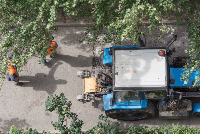 Road Repair. Asphalt Cutting Machine and Road Workers Editorial Stock ...