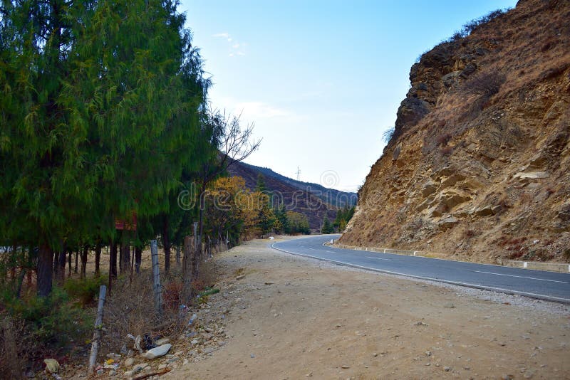 The road beside the rock stock image. Image of perspective - 148678427