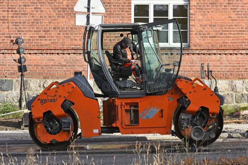 A Road Roller Compacting Asphalt during Operation. Editorial ...