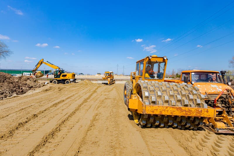 Road Roller with Spikes and Truck Plate Compactor are Working at ...