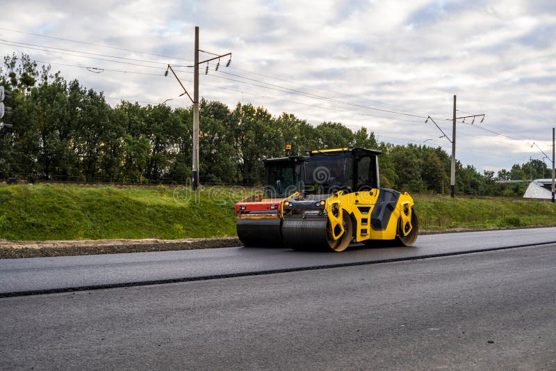 Road Roller Working on Fresh Asphalt Pavement during Construction Near ...