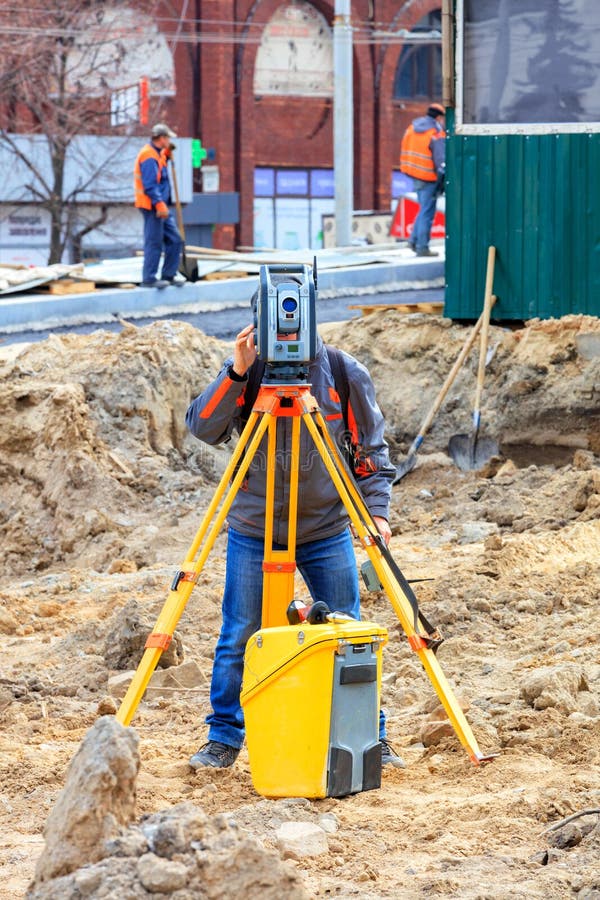 A Road Service Engineer Uses a Laser Level at a Construction Site Stock ...