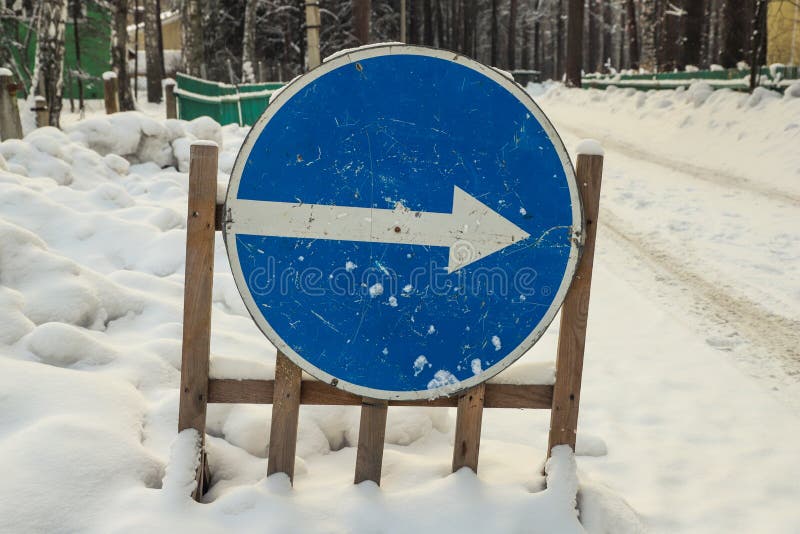 Road Sign with an Arrow Next To the Road Close-up Stock Image - Image ...