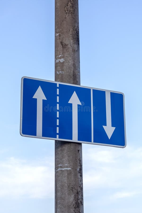 Road Sign with Arrows on Blue Sky Background Stock Photo - Image of ...