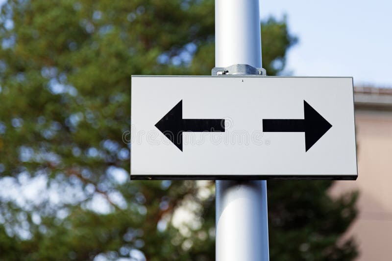 Road Sign with Arrows in Two Different Directions Stock Photo - Image ...