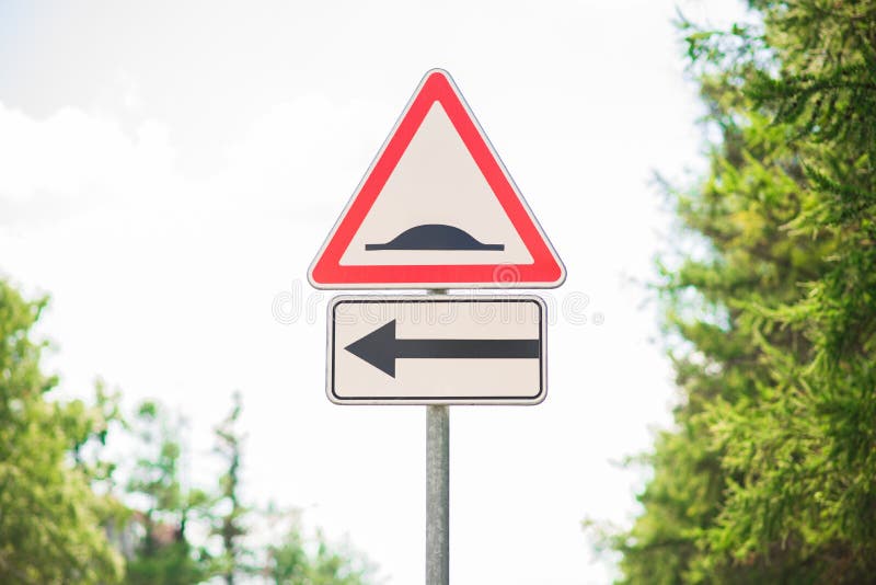 Road Sign Artificial Irregularity and Arrow. a Barrier on the Road. the ...