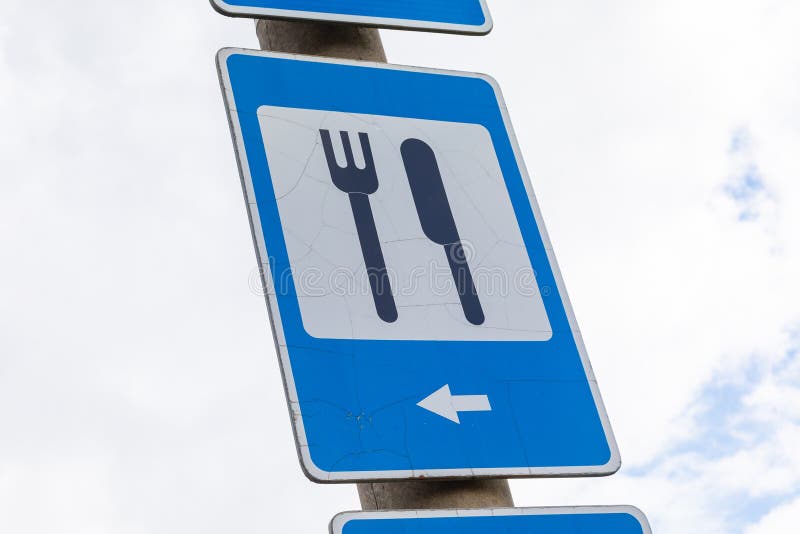 Road Sign Food Services Area with Direction Pointer Against Sky Stock ...