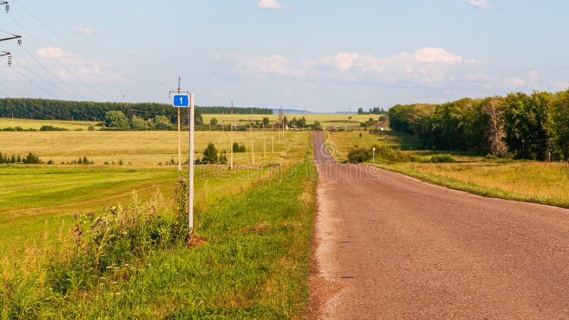 Road Sign Indicating the Distance. Road among Summer Fields and Forests ...