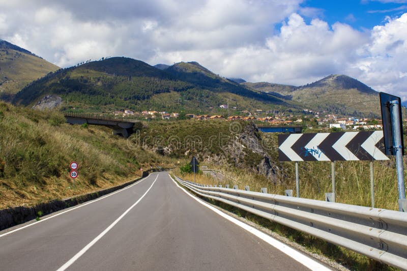 Road Sign Indicating Left Turn. Curve of the Road Stock Photo - Image ...