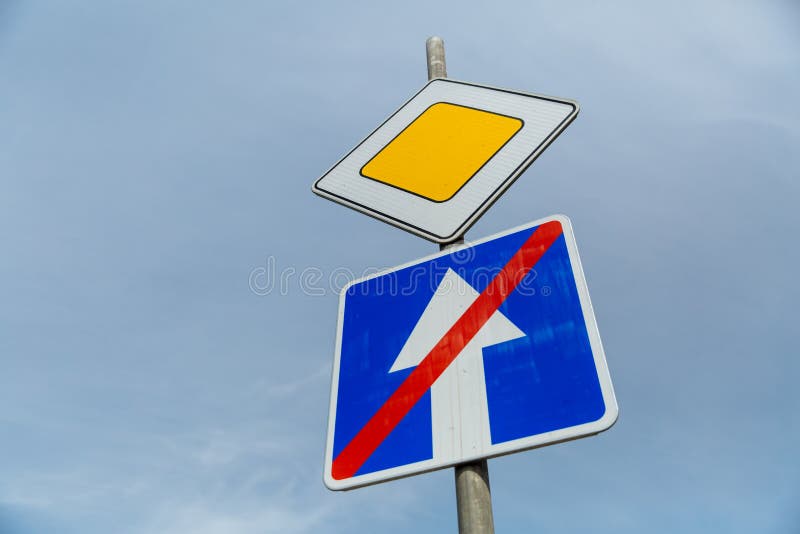 Road Sign Main Road and One-way Road End Sign on Blue Sky Background ...
