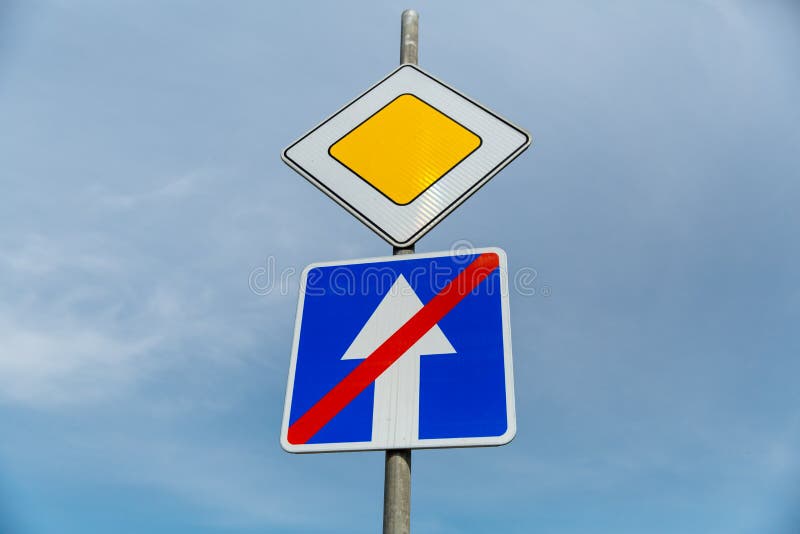 Road Sign Main Road and One-way Road End Sign on Blue Sky Background ...