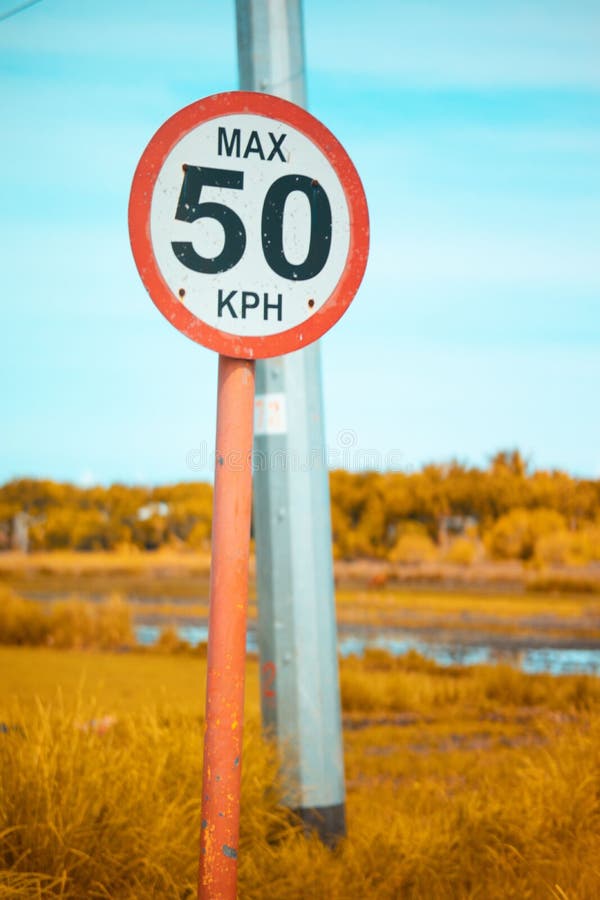 Road Sign with a Maximum of 50 KPH Limit Against a Blurred Background ...