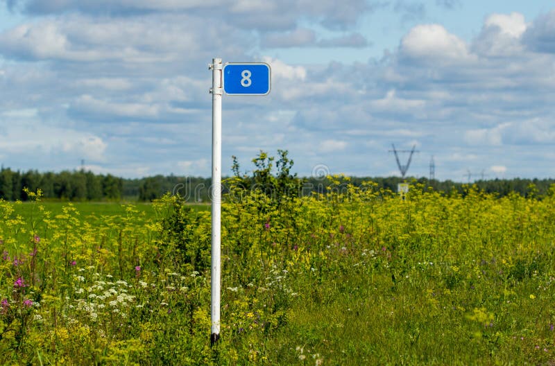 Road Sign Mileage Installed in the Field Stock Photo - Image of field ...
