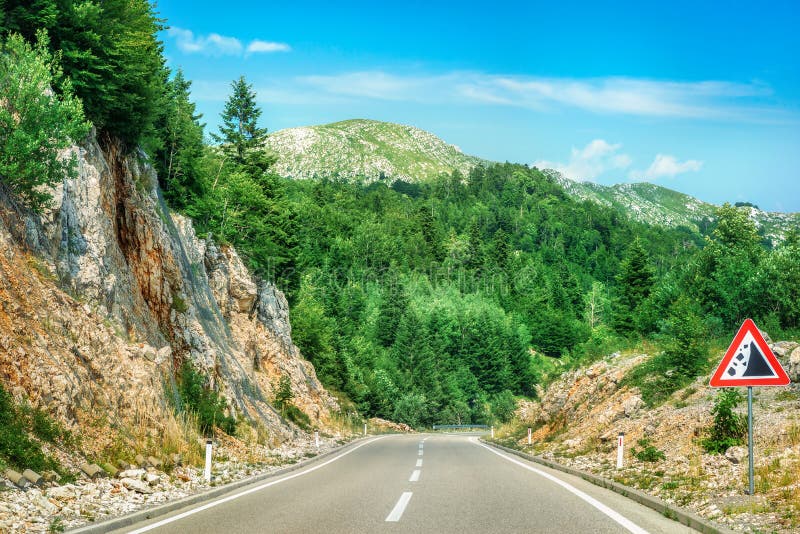 Road sign in mountains stock image. Image of dividing - 196832759