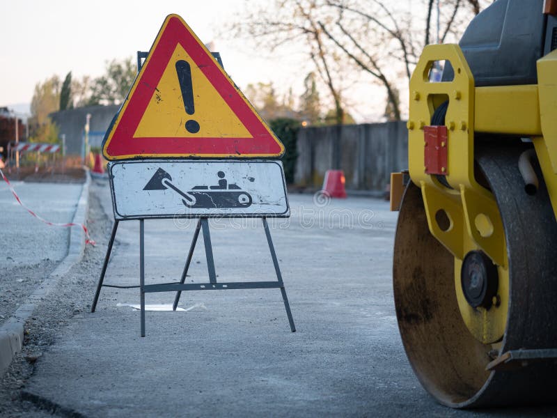 Road Sign Showing Work in Progress and Big Machine for Asphalt ...